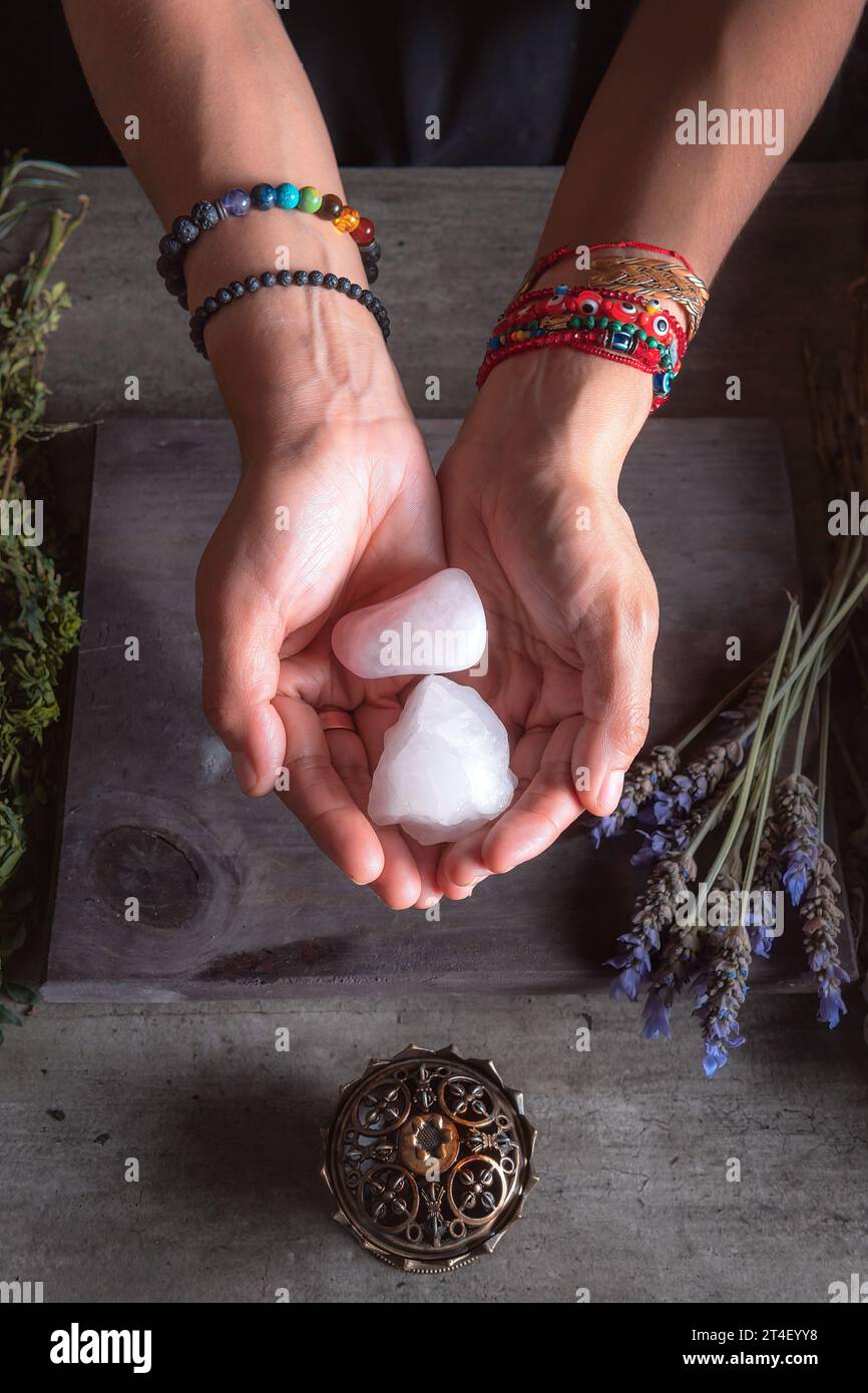 woman holding rose quartz with her hands for spiritual and traditional ...