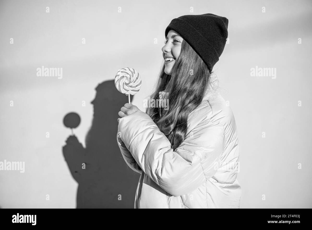 photo of glad girl with yummy lollypop outside. girl with yummy ...