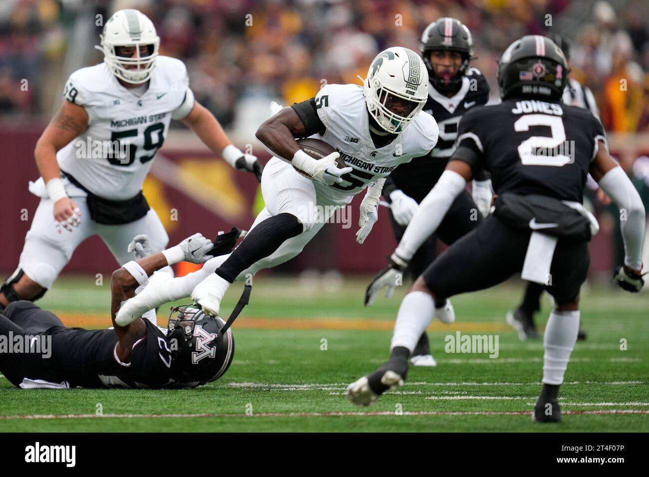 Michigan State running back Nathan Carter (5), center, runs with the ...
