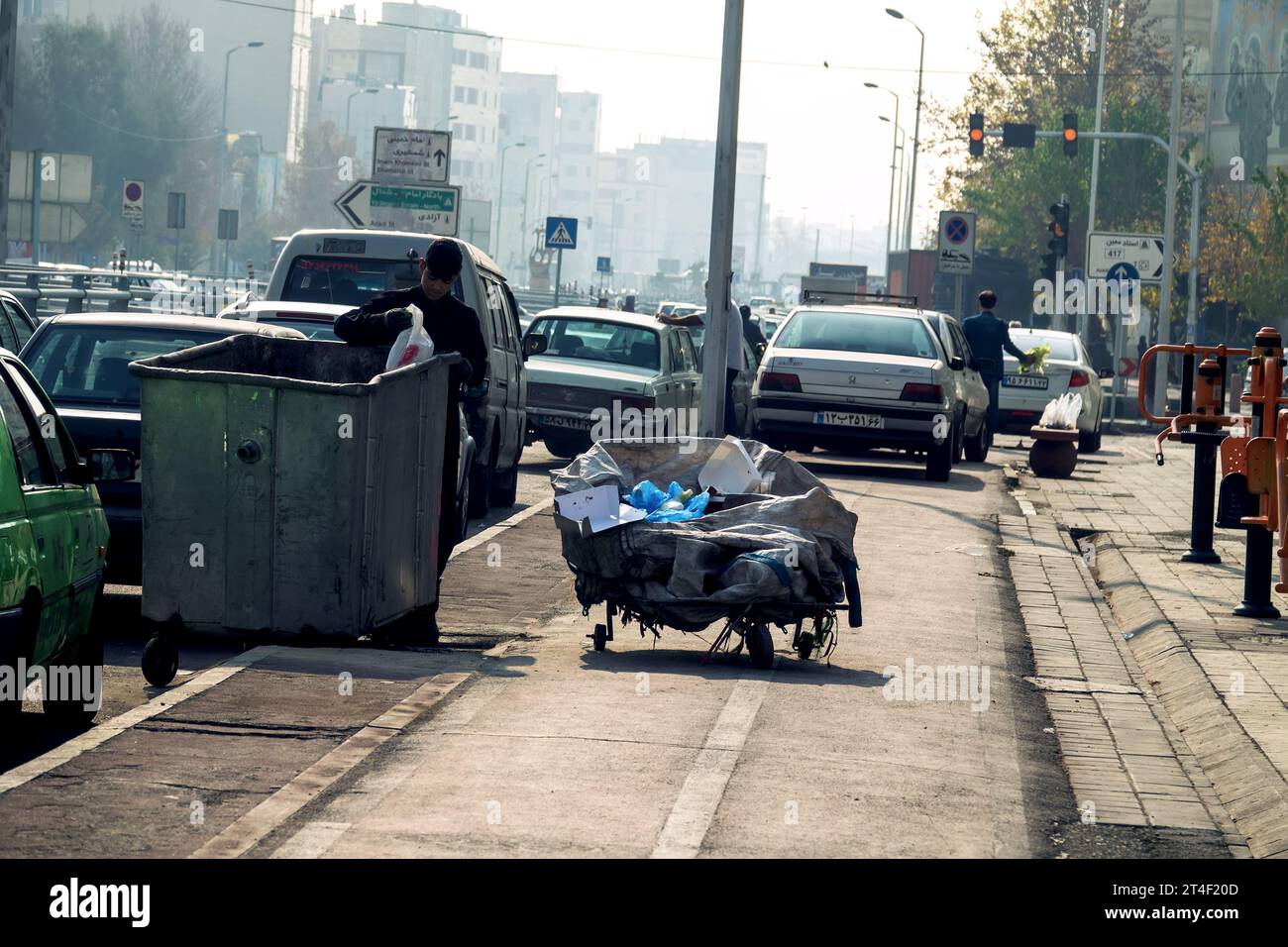 Tehran, Iran- December 19, 2022: Garbage containers and junk man Stock ...