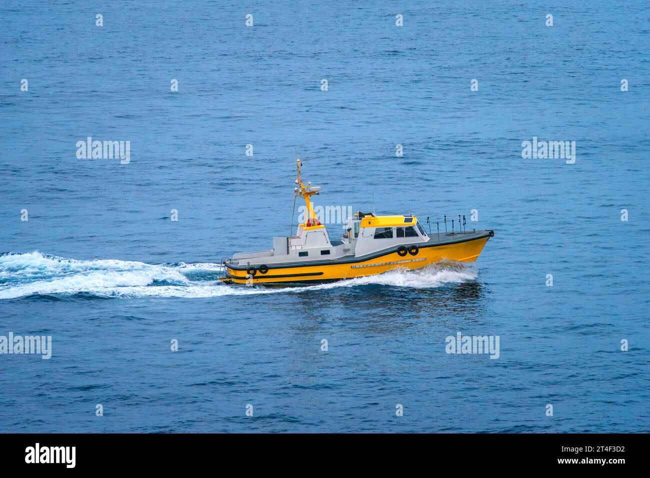 A yellow pilot boat speeding on the ocean water Stock Photo - Alamy