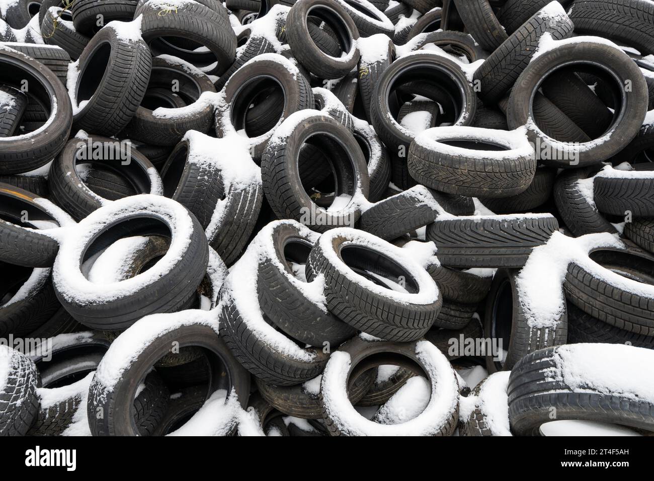 Pile of old tyres covered by snow. Black and white photography Stock ...