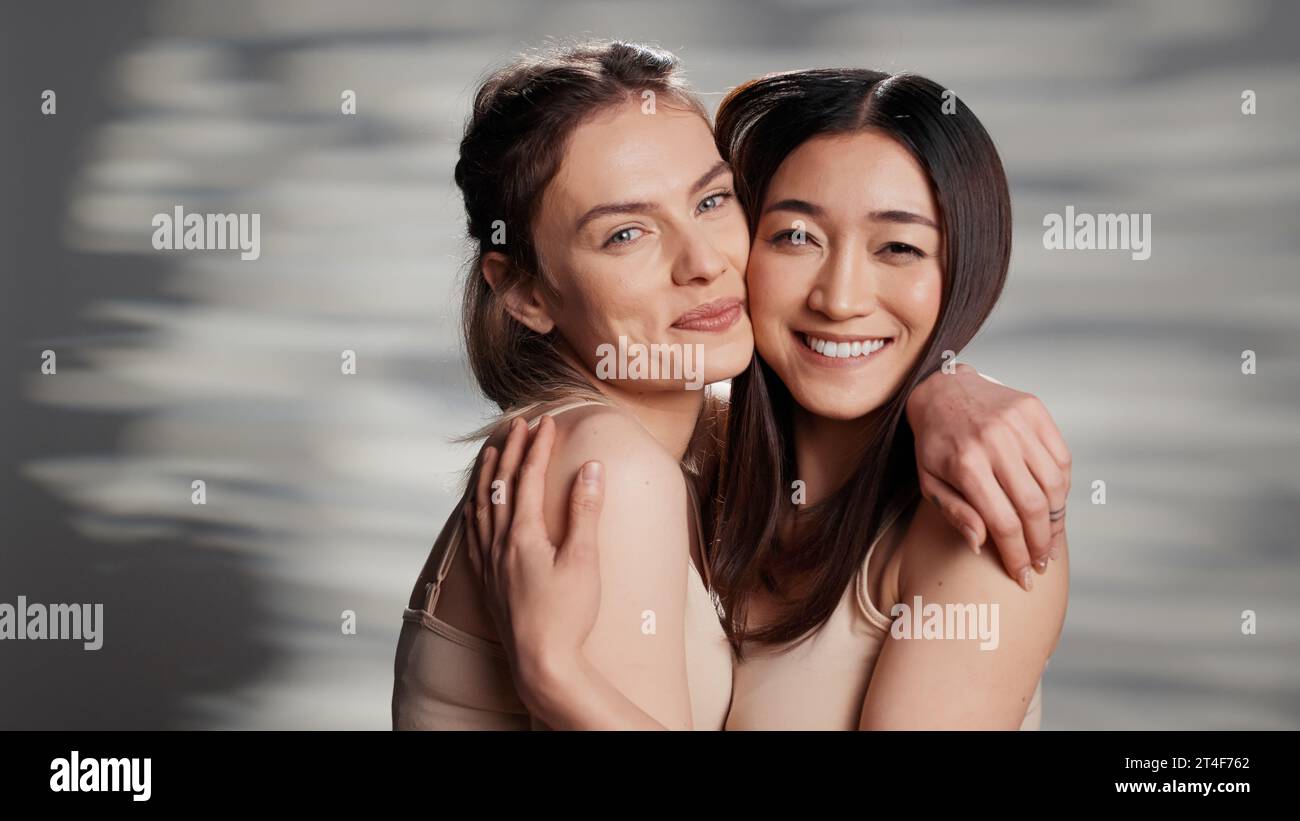 Cheerful beauty models posing on camera for campaign, advertising self ...