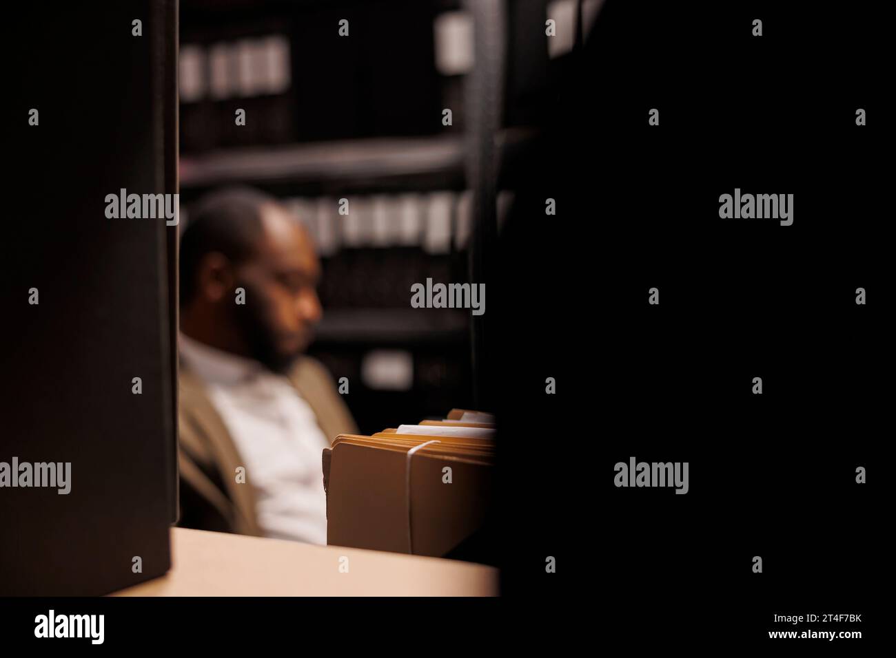 Shelf with criminal case files and policeman in dark police office ...