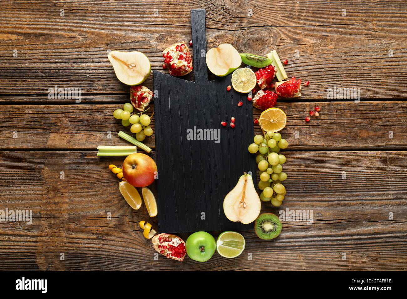 Composition with cutting board, fresh vegetables and fruits on wooden ...