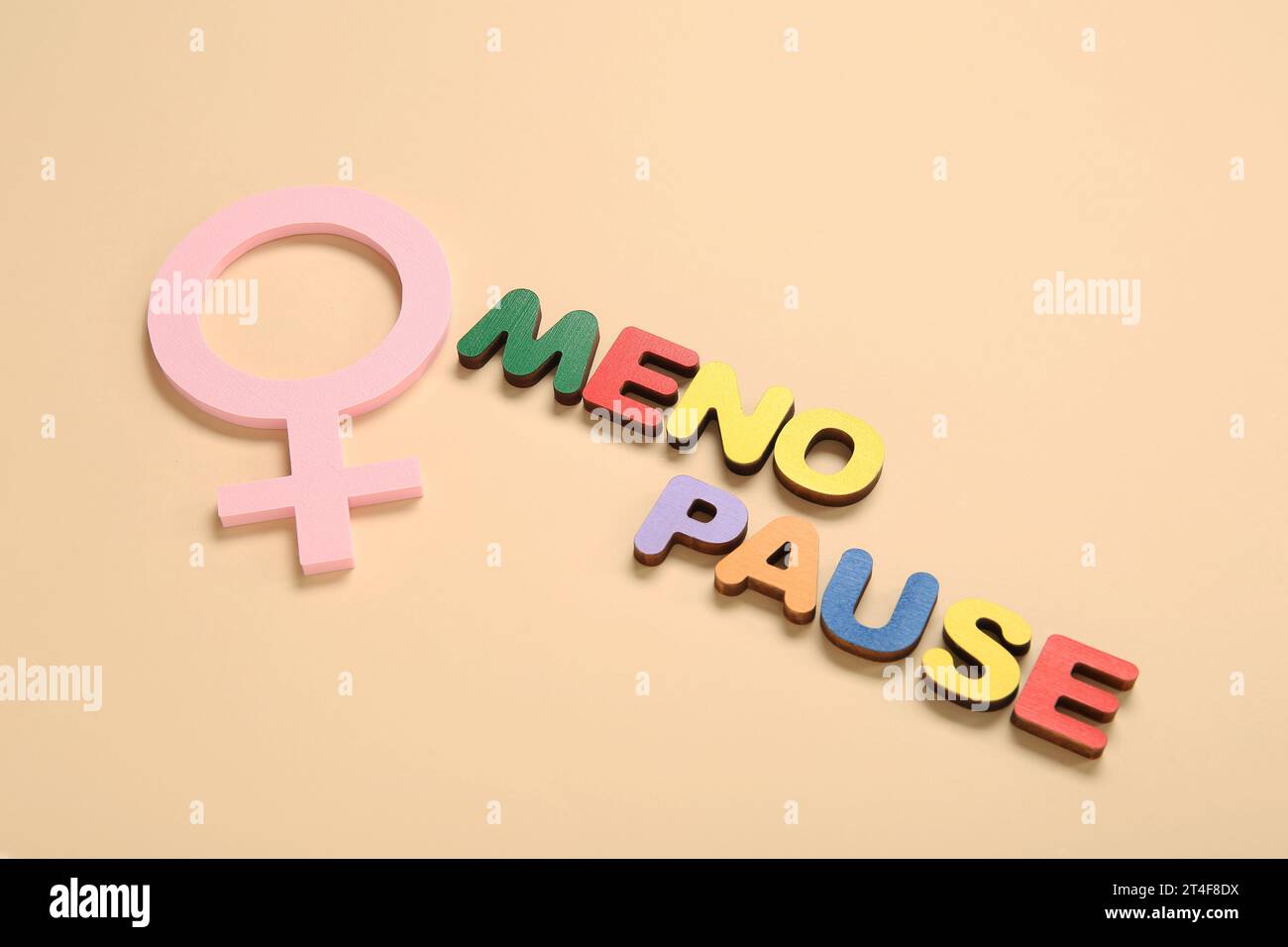 Word MENOPAUSE with symbol of woman on beige background Stock Photo - Alamy