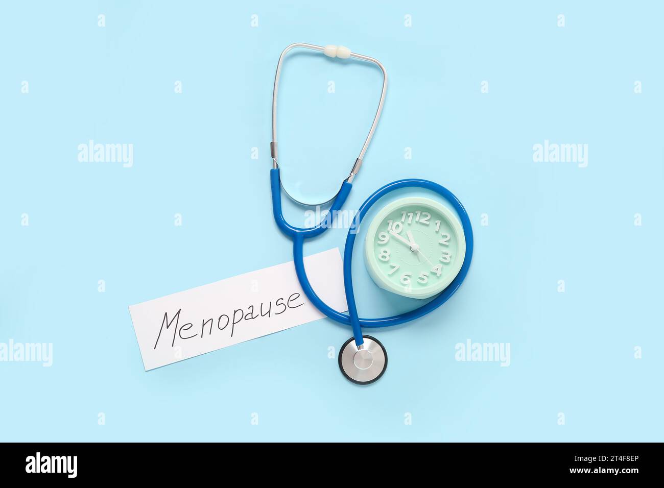 Word MENOPAUSE with stethoscope and clock on blue background Stock ...