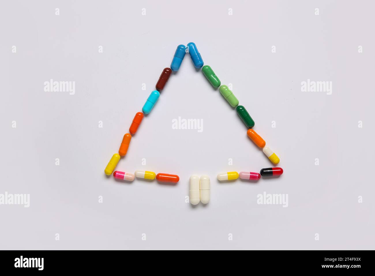 Christmas tree made of colorful pills on white background Stock Photo ...