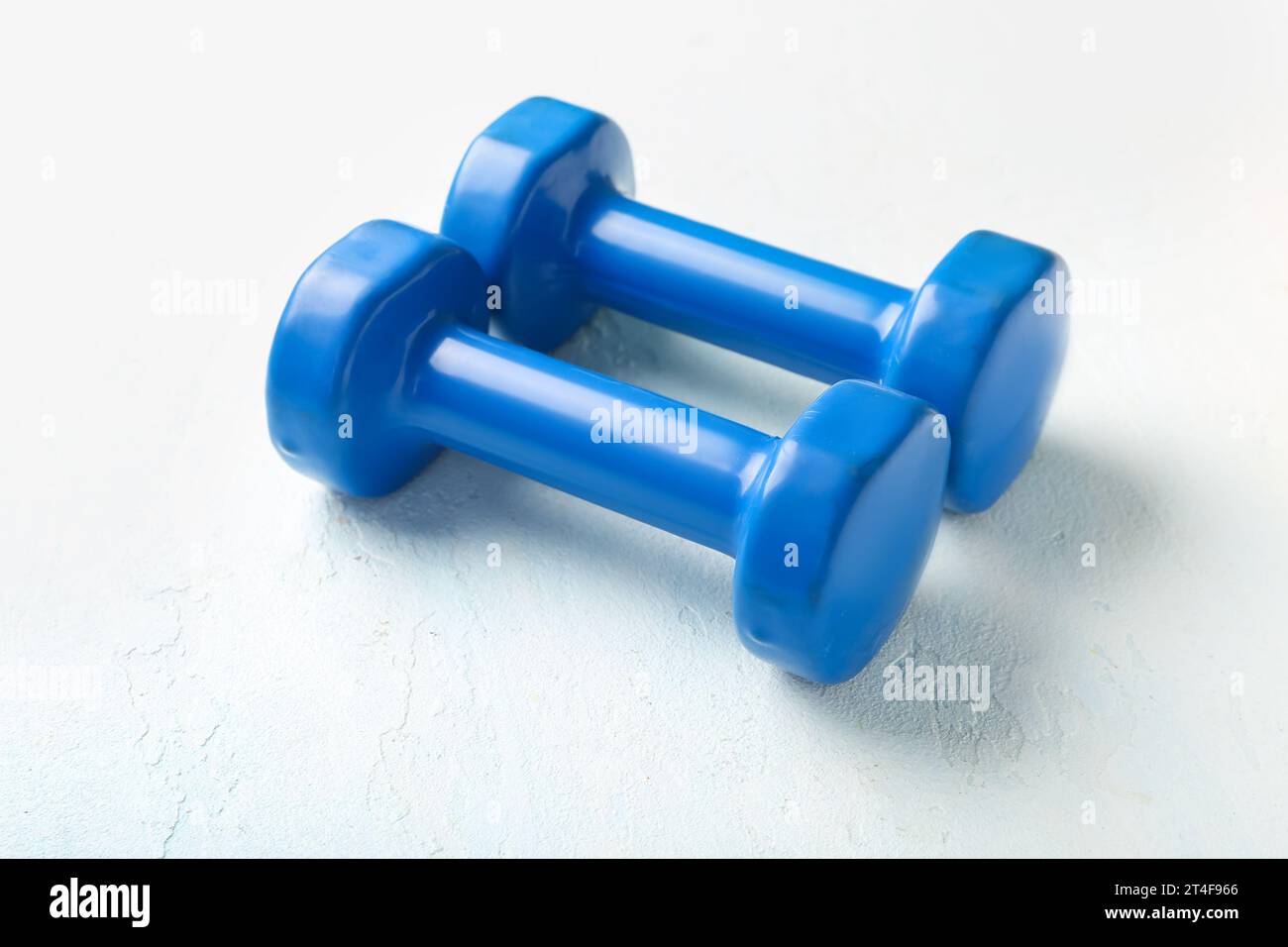 Blue dumbbells on white background Stock Photo - Alamy