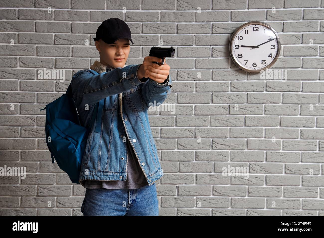 Male student with gun in hall. School shooting concept Stock Photo - Alamy