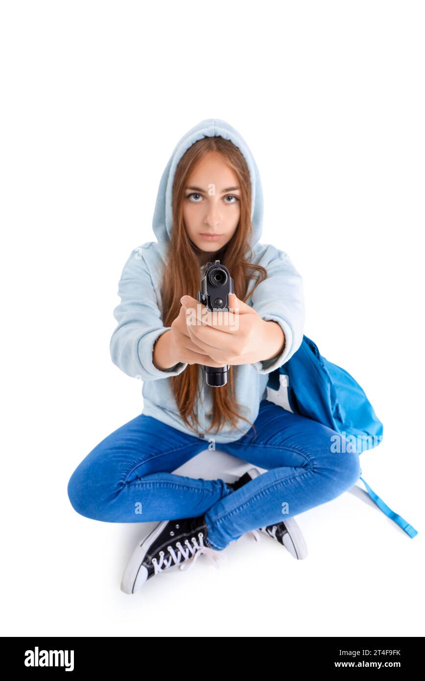Female student with gun sitting on white background. School shooting ...