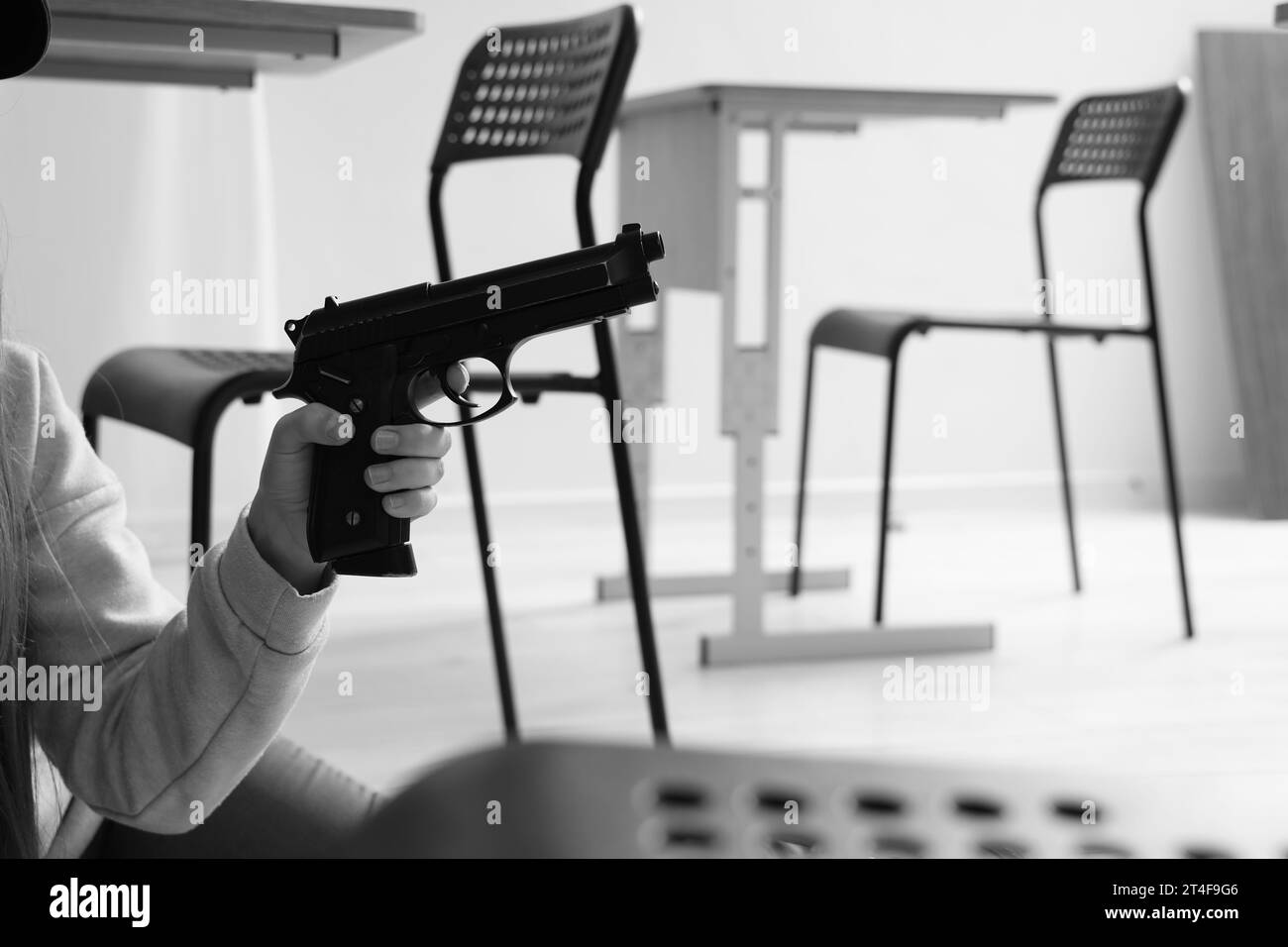 Female student with gun in classroom, closeup Stock Photo - Alamy