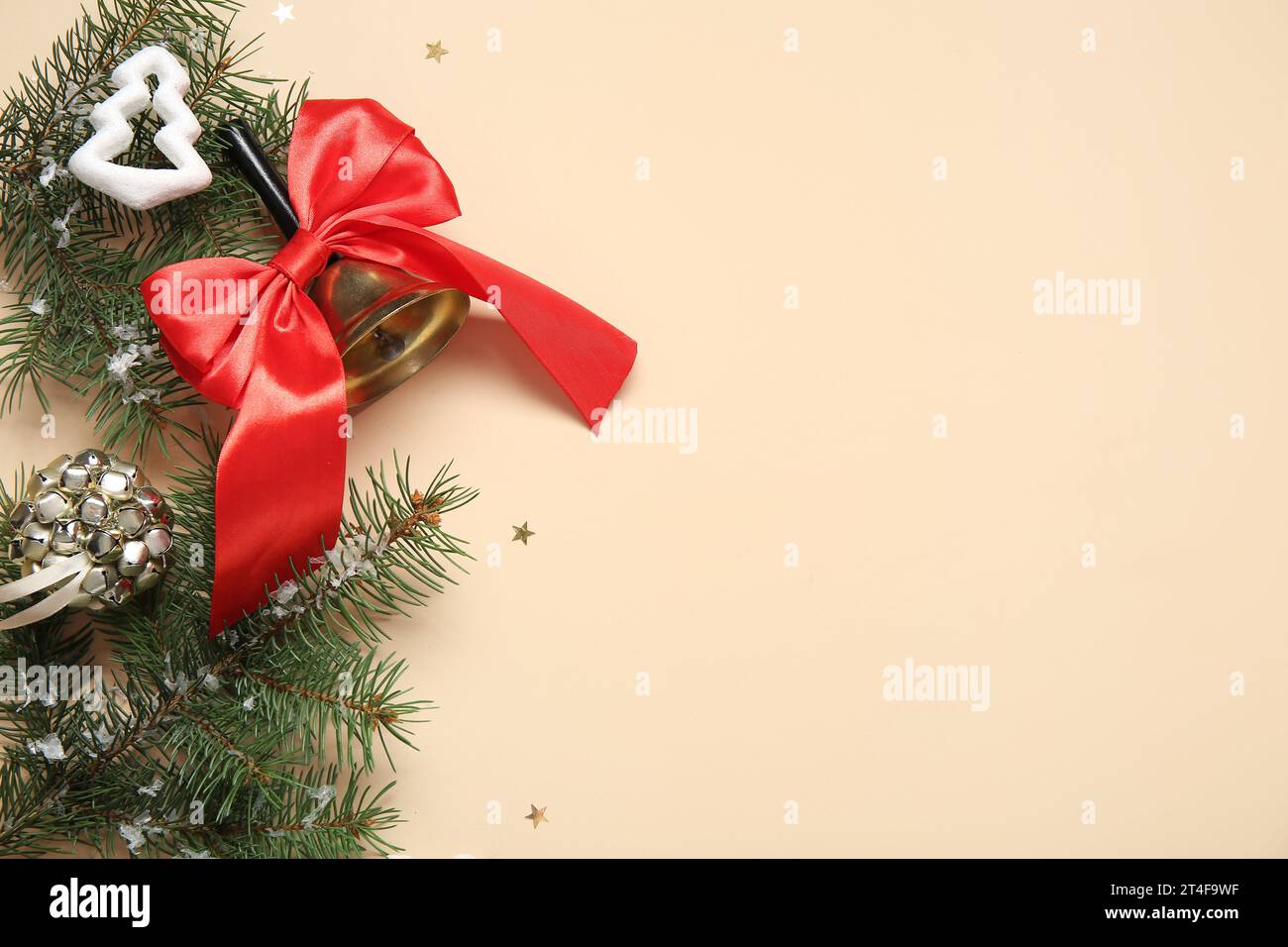 Christmas bell with fir branches and beautiful decorations on beige ...