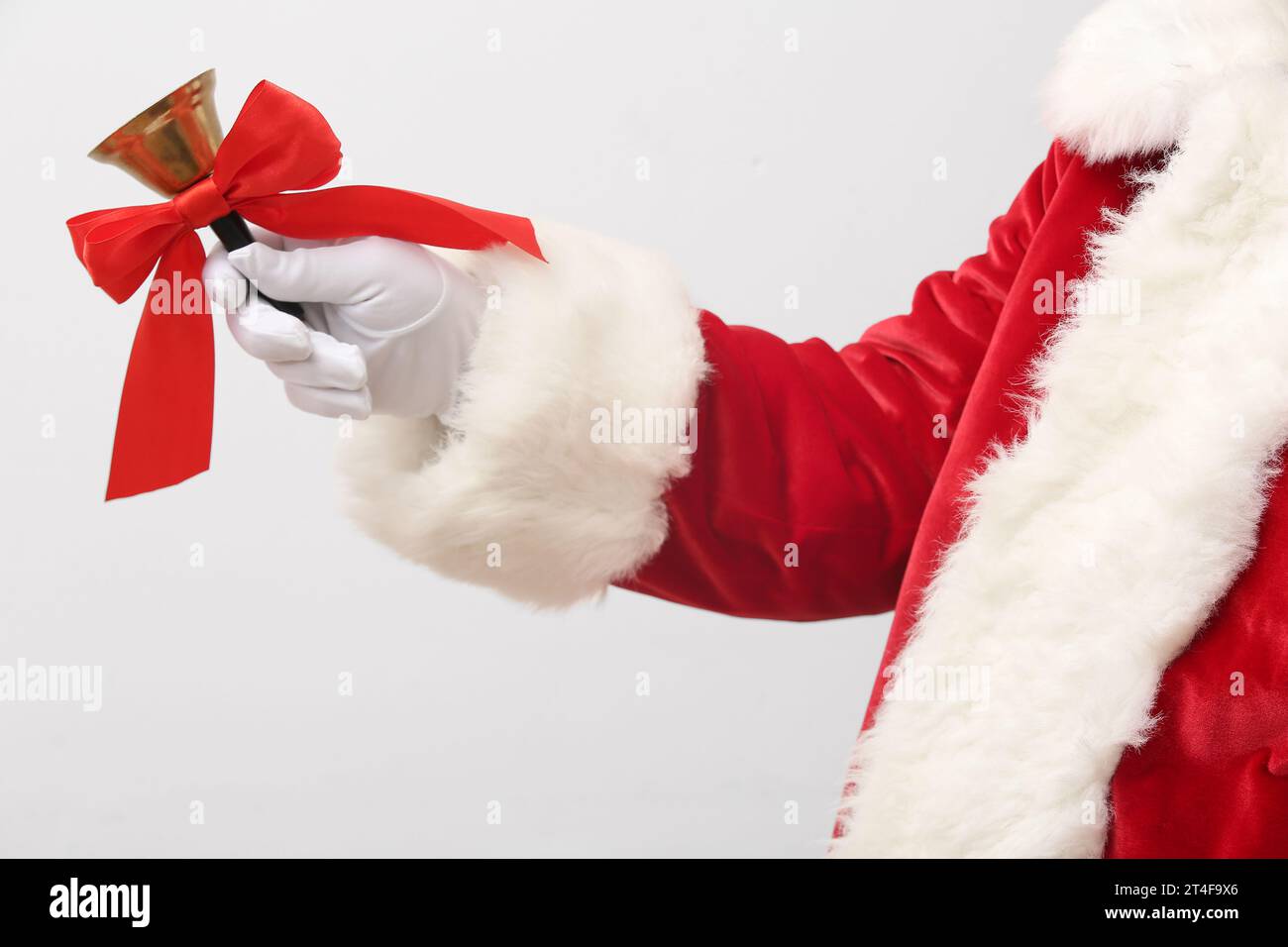 Santa Claus holding Christmas bell with red bow on white background ...