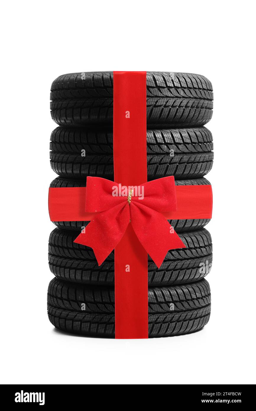 Studio shot of a pile of vehicle tires with red ribbon bow isolated on ...