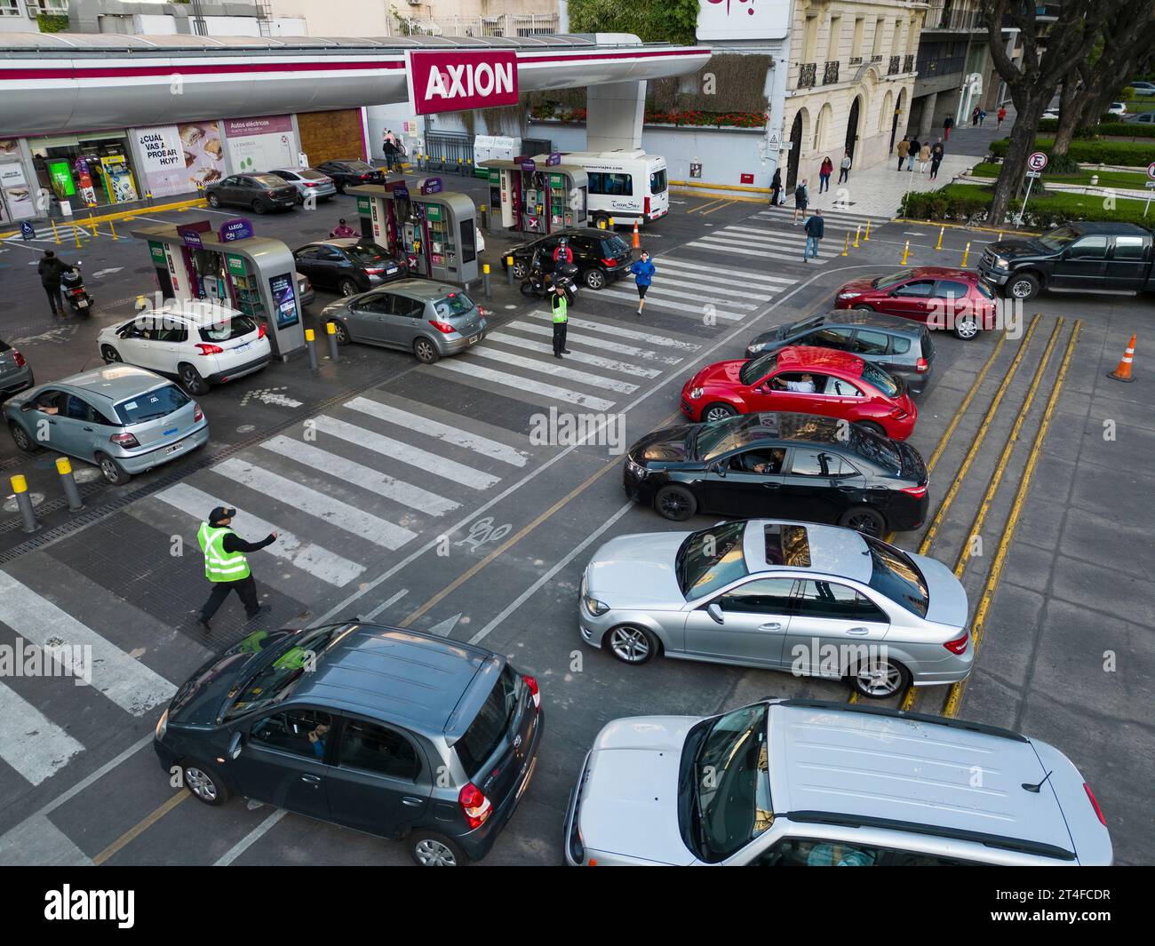 Drivers wait in line to refuel their vehicles at a fuel station in Buenos Aires, Argentina ...