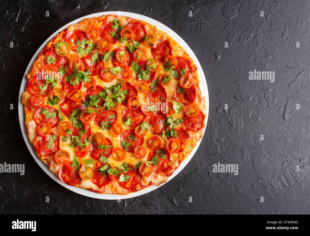 Pizza with sausage and cilantro, ready to eat Stock Photo - Alamy