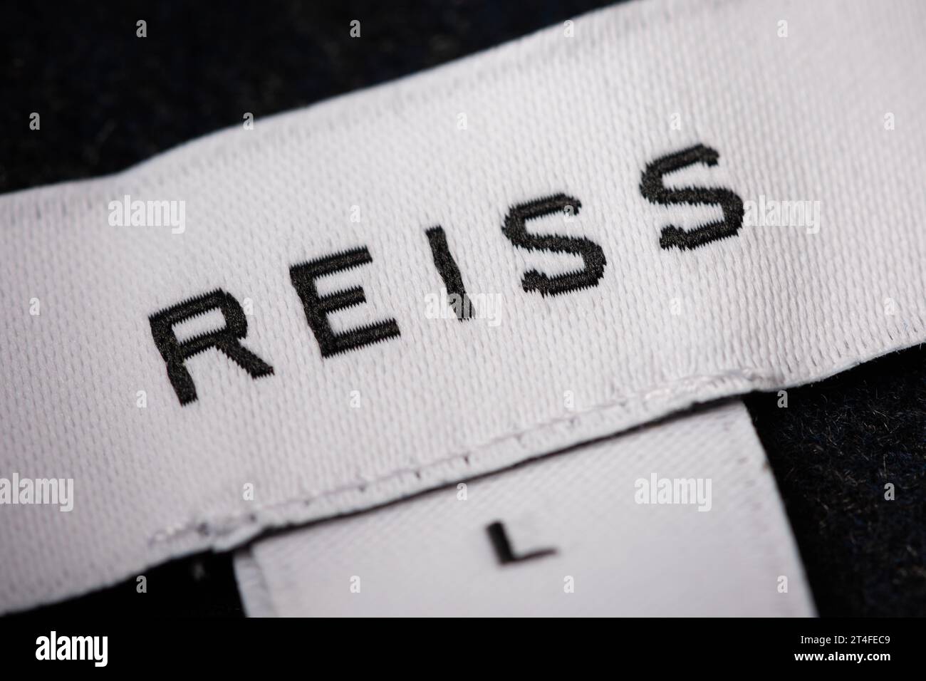 A close-up of an embroidered Reiss logo as seen on a tag Stock Photo ...
