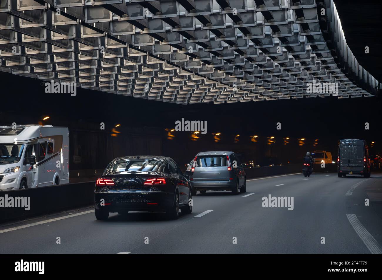 Driving in tunnel in heavy traffic on ring road of capital of France ...