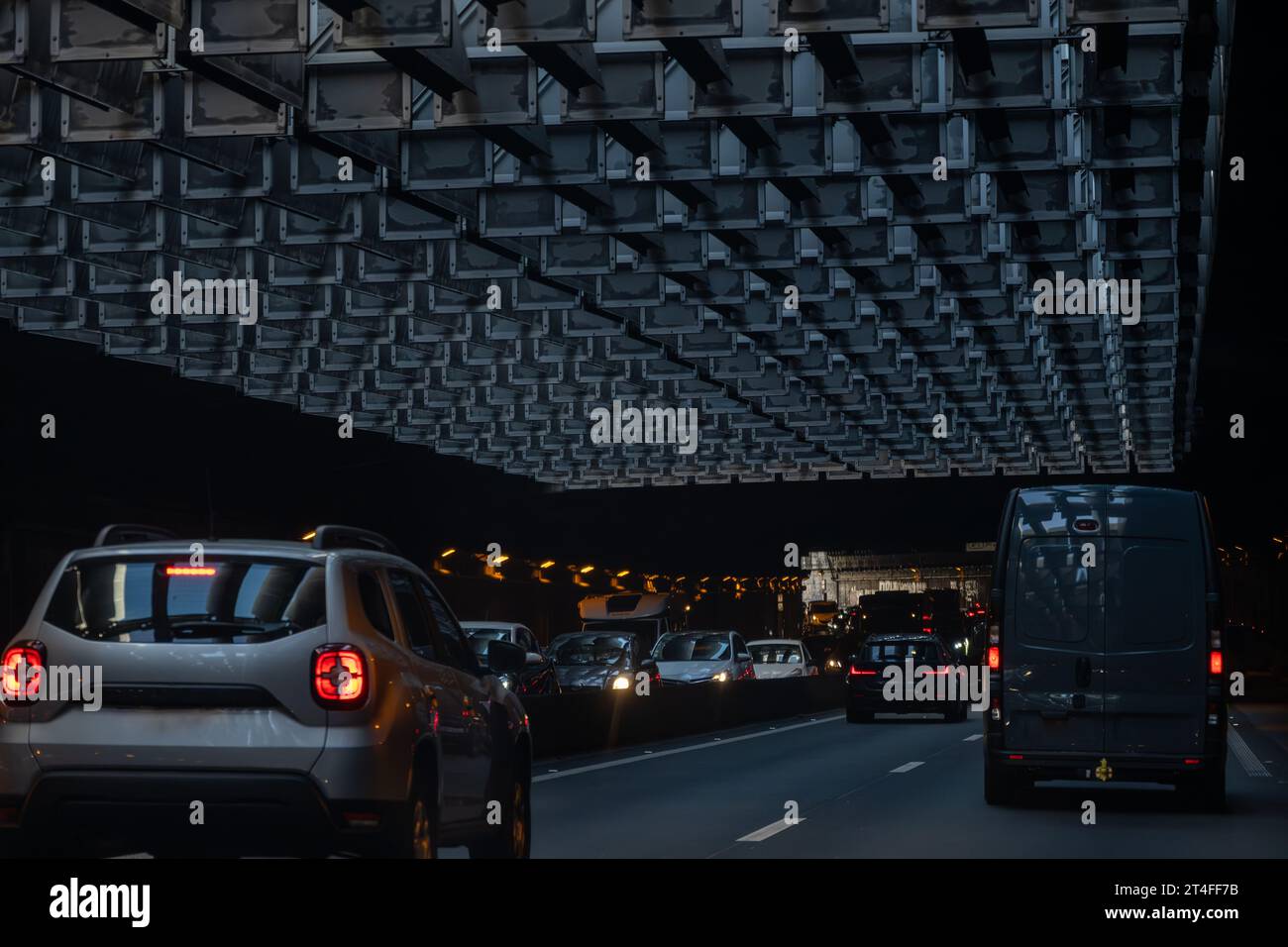 Driving in tunnel in heavy traffic on ring road of capital of France ...