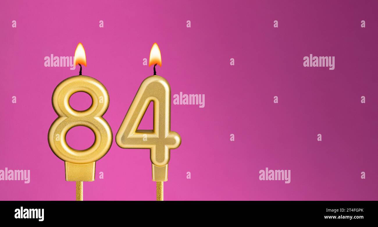 Birthday card with candle number 84 - purple background Stock Photo - Alamy