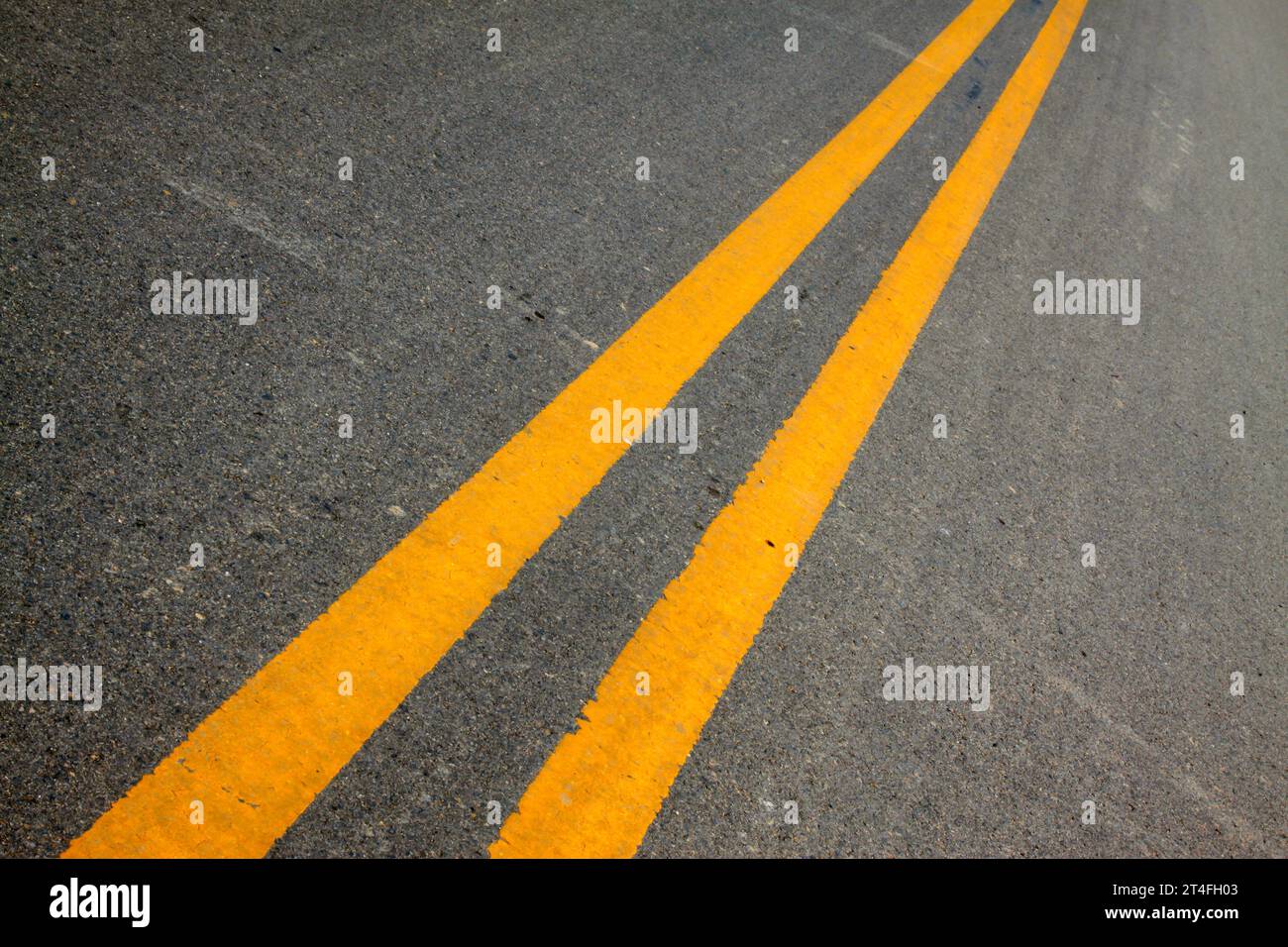 yellow double solid line on the road Stock Photo - Alamy
