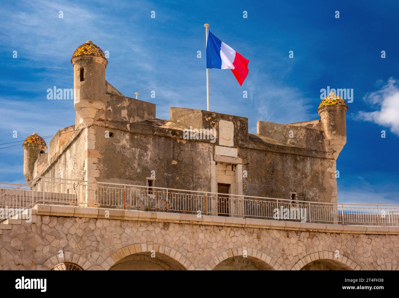The French flag flies over Old bastion fort on the seashore in Menton ...