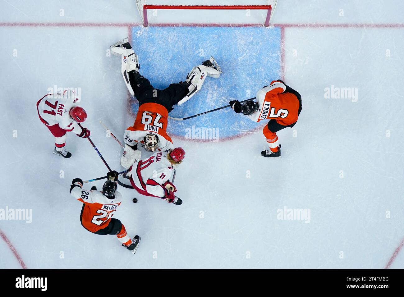 Philadelphia Flyers' Carter Hart (79) dives for the puck as Egor Zamula ...