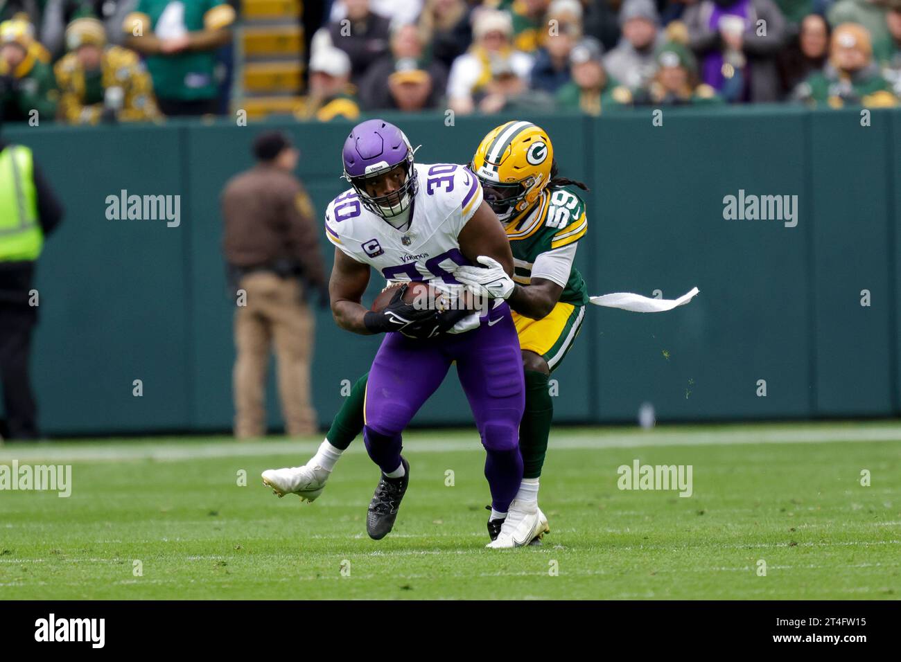 Minnesota Vikings fullback C.J. Ham (30) is hit by Green Bay Packers ...