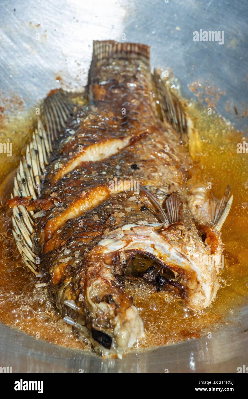 Fish fried in hot oil hi-res stock photography and images - Alamy