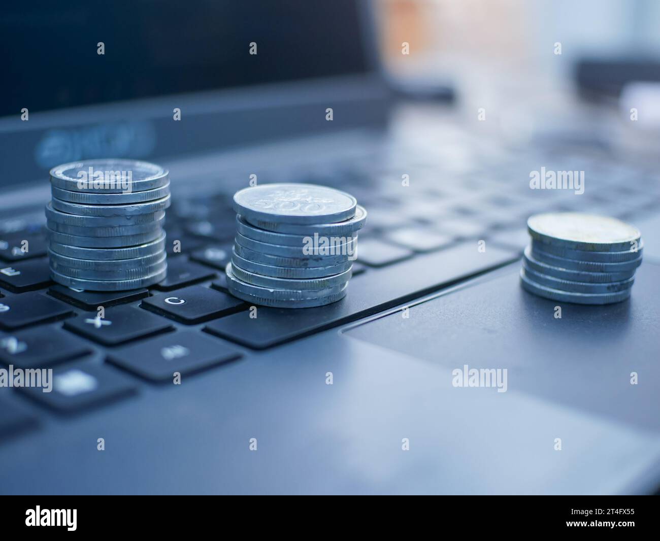stack coins on the laptop keyboard Stock Photo - Alamy