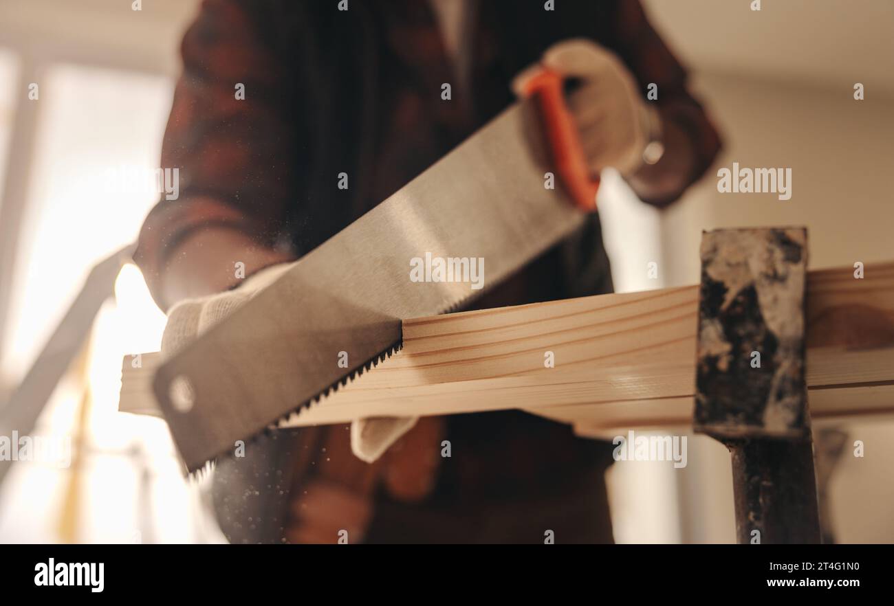 Construction worker renovating a home's interior kitchen. Using a ...