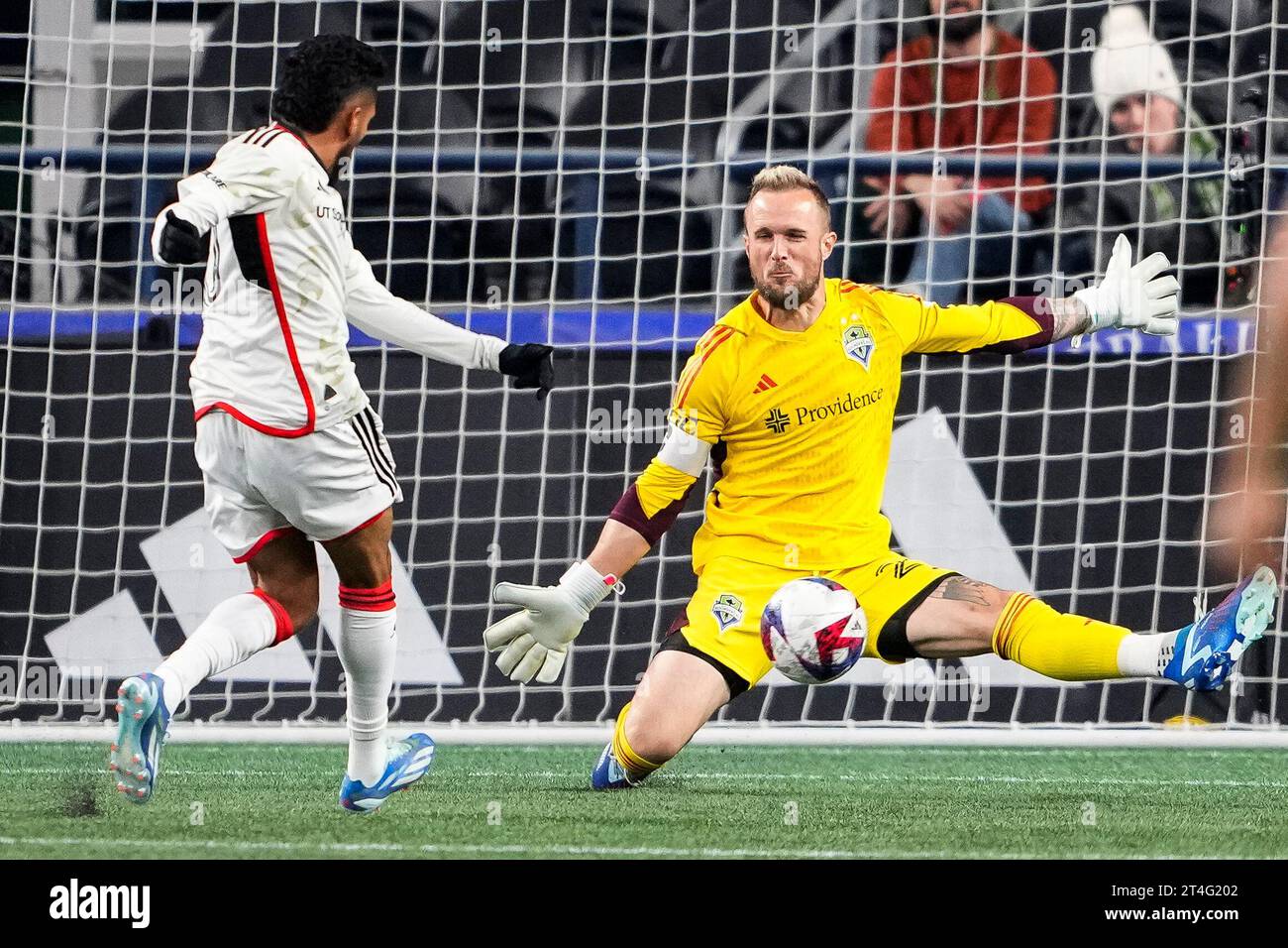 Seattle Sounders goalkeeper Stefan Frei, right, reaches to make a point ...