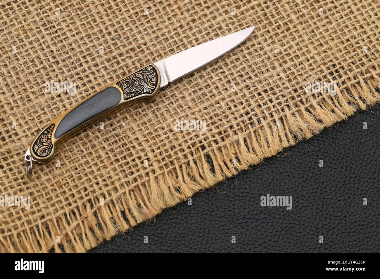 Close up photo of small folding knife on hemp cloth background Stock ...