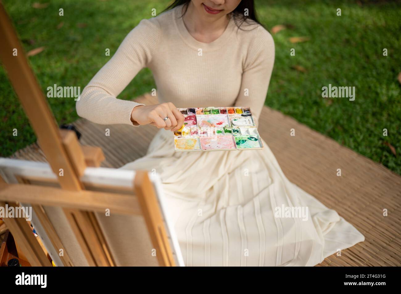 Close-up image of a talented and creative young Asian female artist is ...