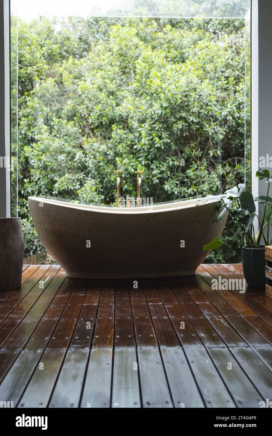 Modern bath by huge window with view on trees in sunny bathroom Stock ...