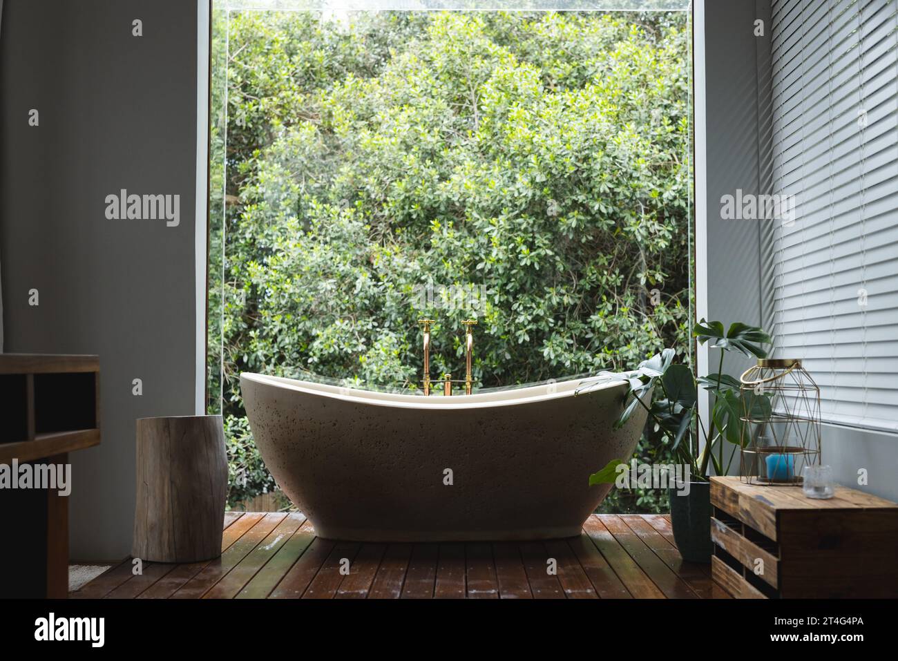 Modern bath by huge window with view on trees in sunny bathroom Stock ...