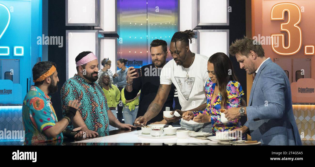 CRIME SCENE KITCHEN, from left: contestants Fadi, T, host Joel McHale ...