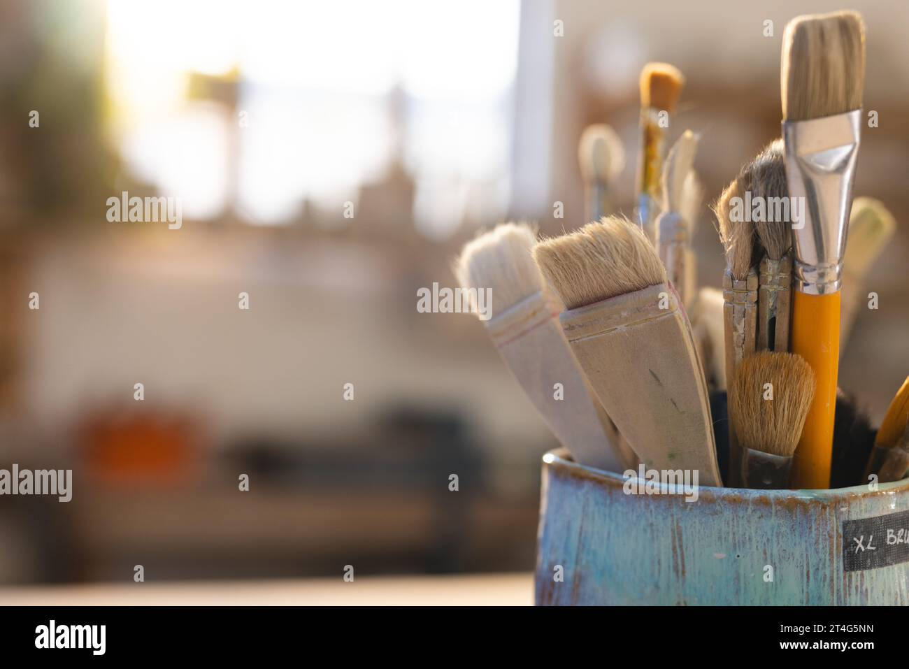 Close up of pottery brushes in clay cups in pottery studio Stock Photo ...