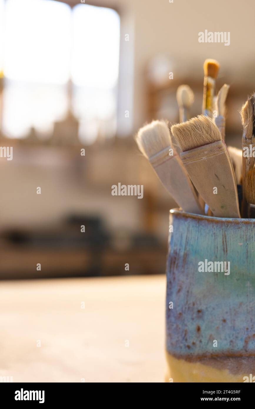 Close up of pottery brushes in clay cups in pottery studio Stock Photo ...