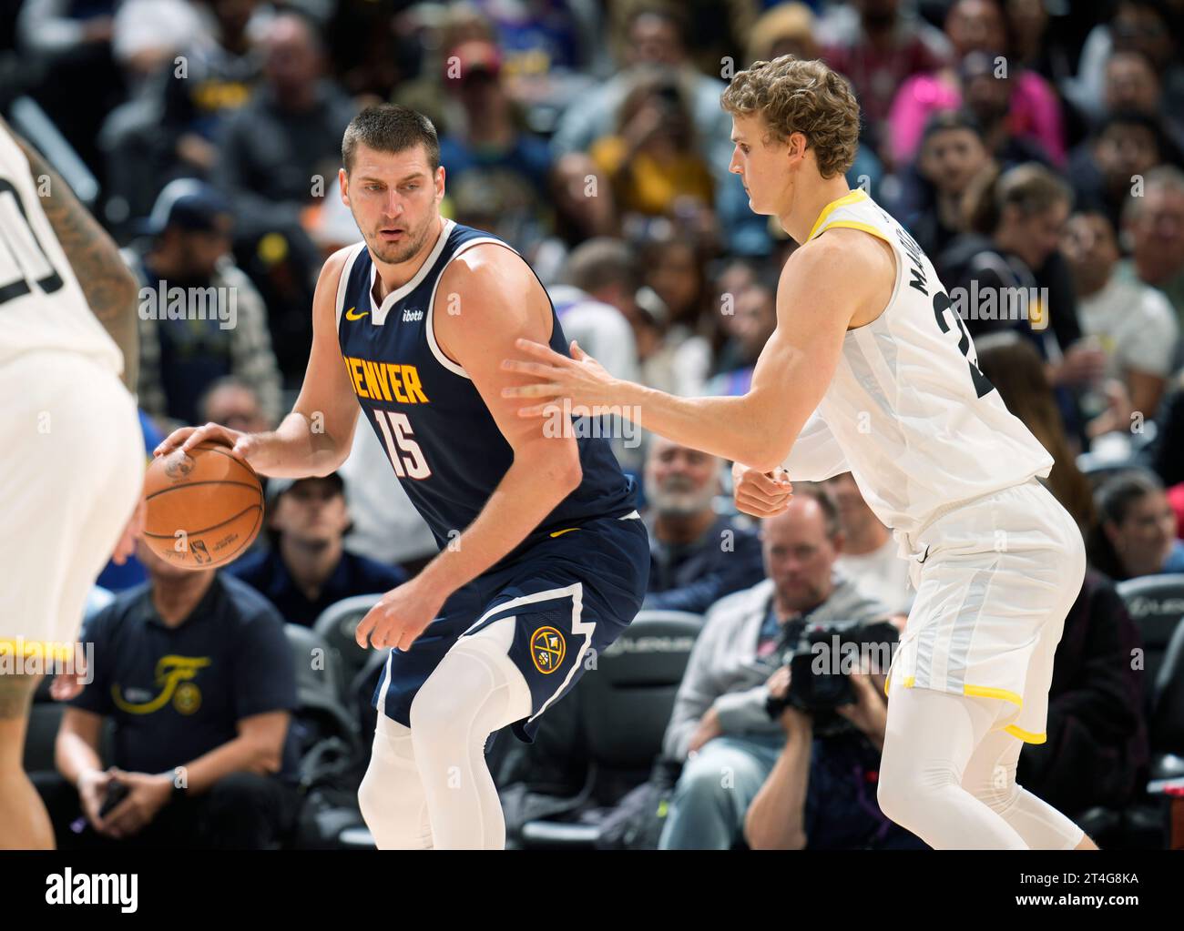 Denver Nuggets center Nikola Jokic, left, drives to the basket as Utah Jazz forward Lauri ...