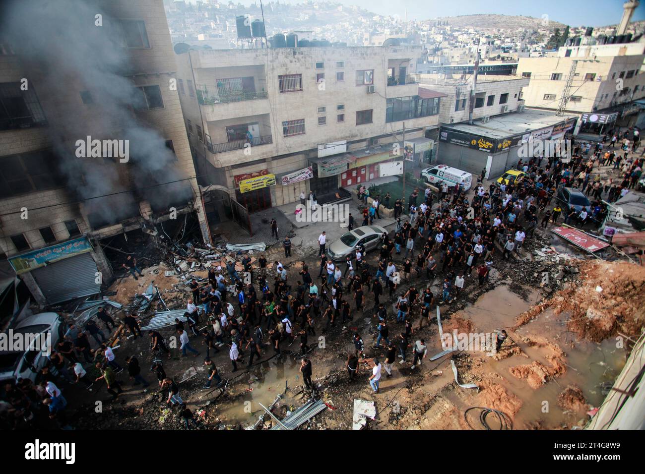 Jenin, Palestine. 30th Oct, 2023. Palestinians inspect the damage ...