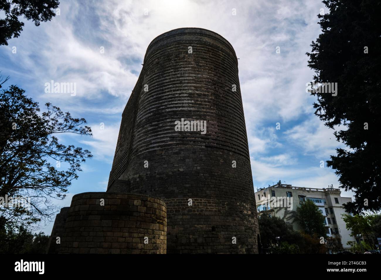 A silhouette view of the tall, round, circular, stone Maiden Tower, Qız ...