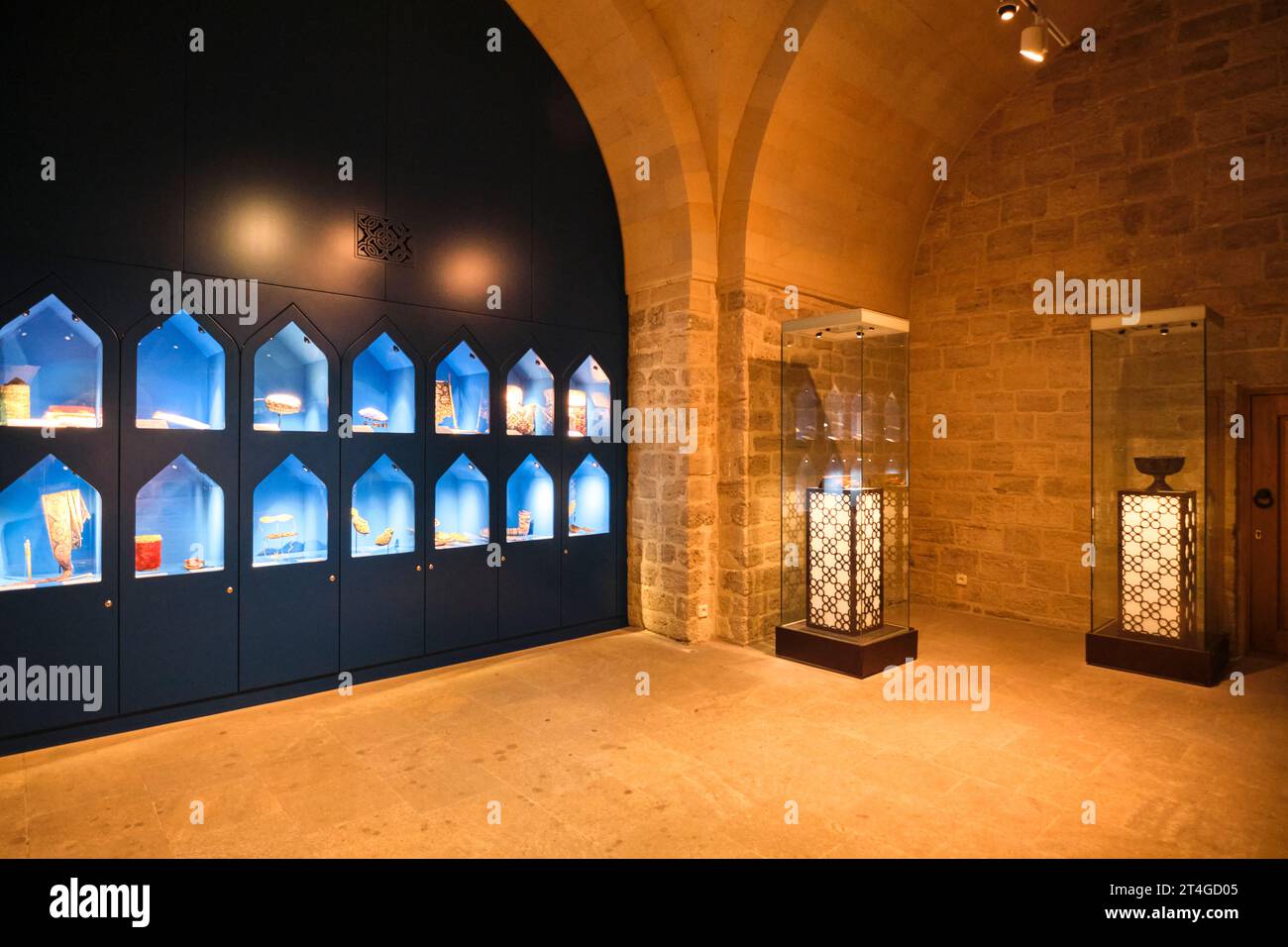 A room at the palace museum with various display cases showing rich ...