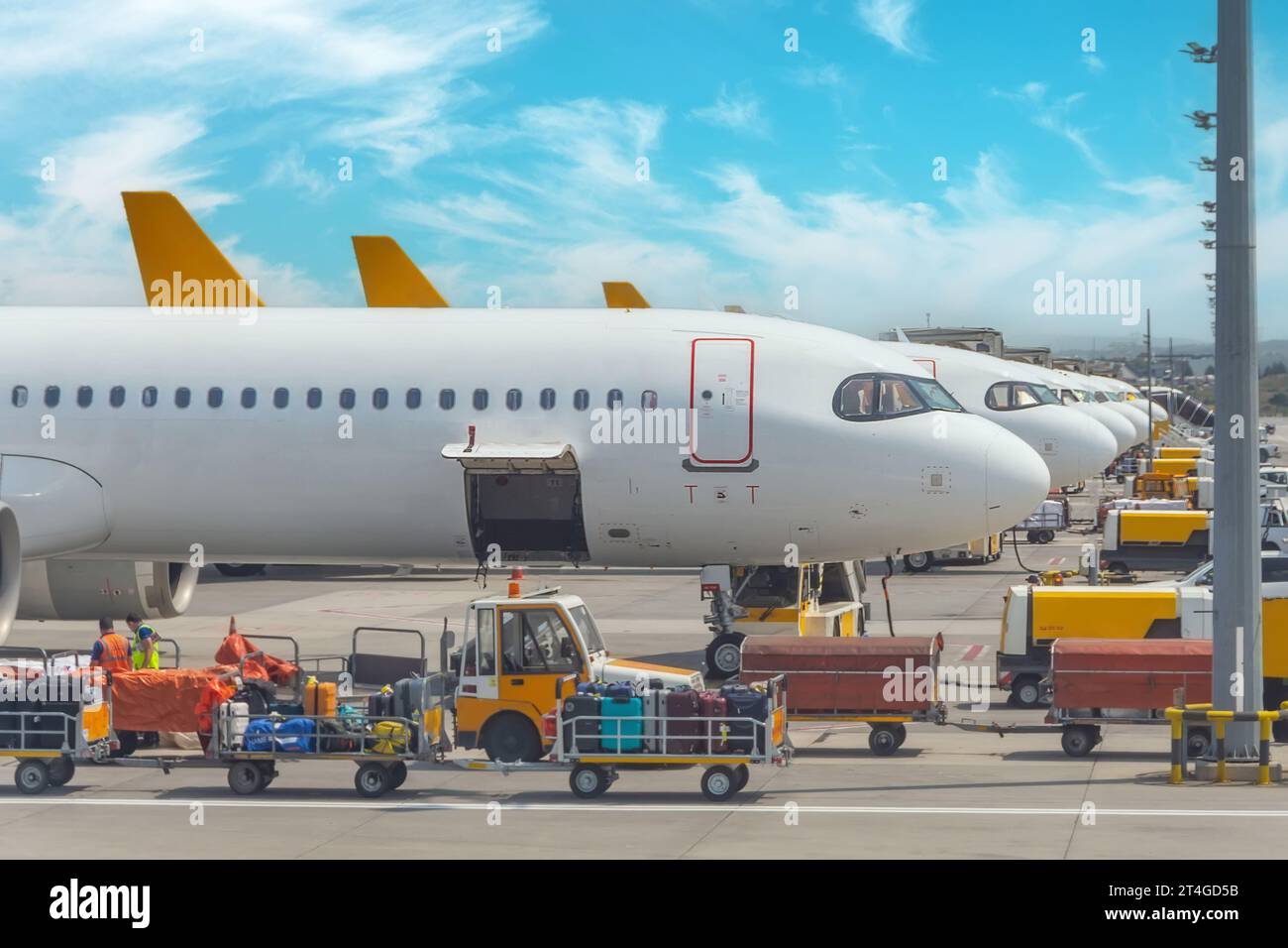 Several planes in a row in the airport parking lot undergoing ...