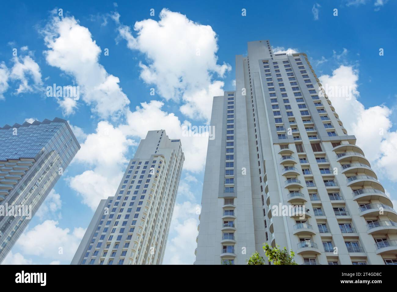 Look up at urban buildings, residential skyscrapers, cumulus white ...