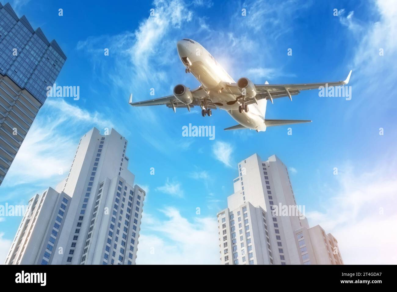Airplane flying over high buildings hi-res stock photography and images ...