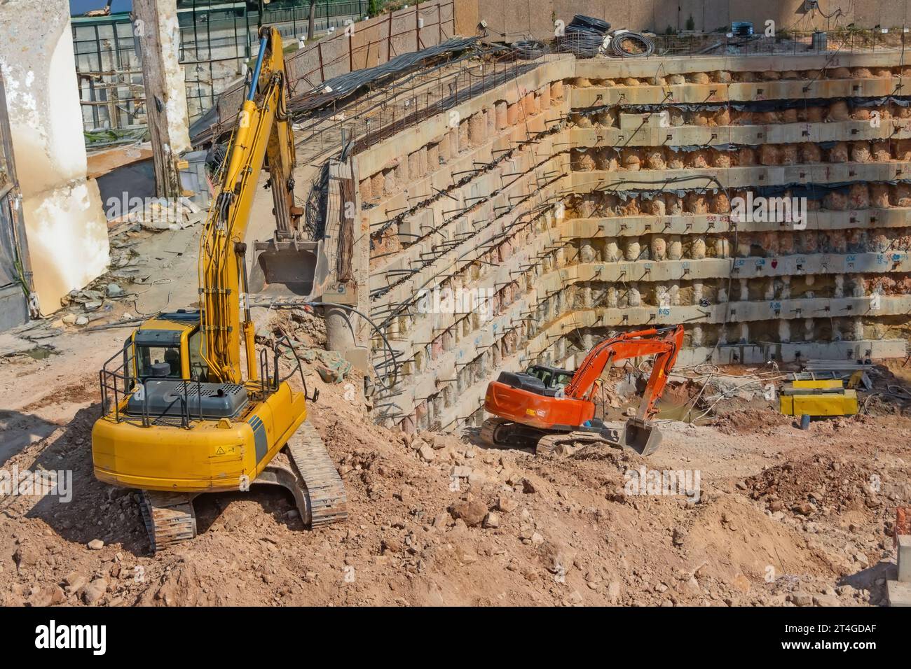 Pit of metro station with piles ground, two working excavator dig and ...