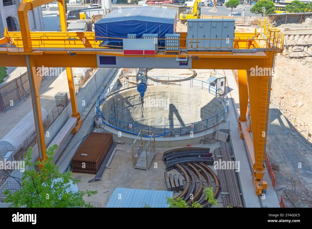Metal crane for installing a frame into an excavated subway tunnel ...