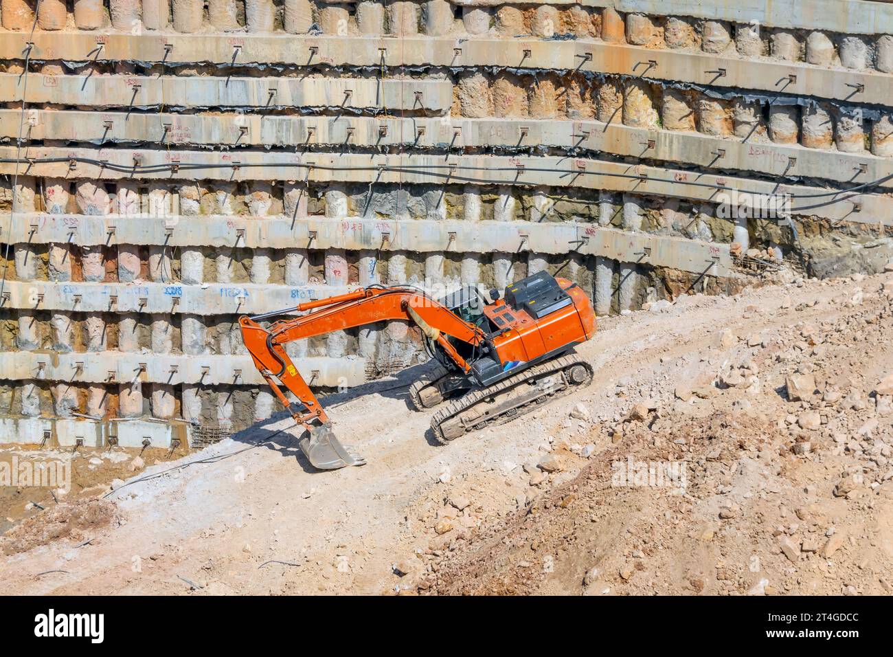 Pit of a metro station with piles in the ground, working orange ...
